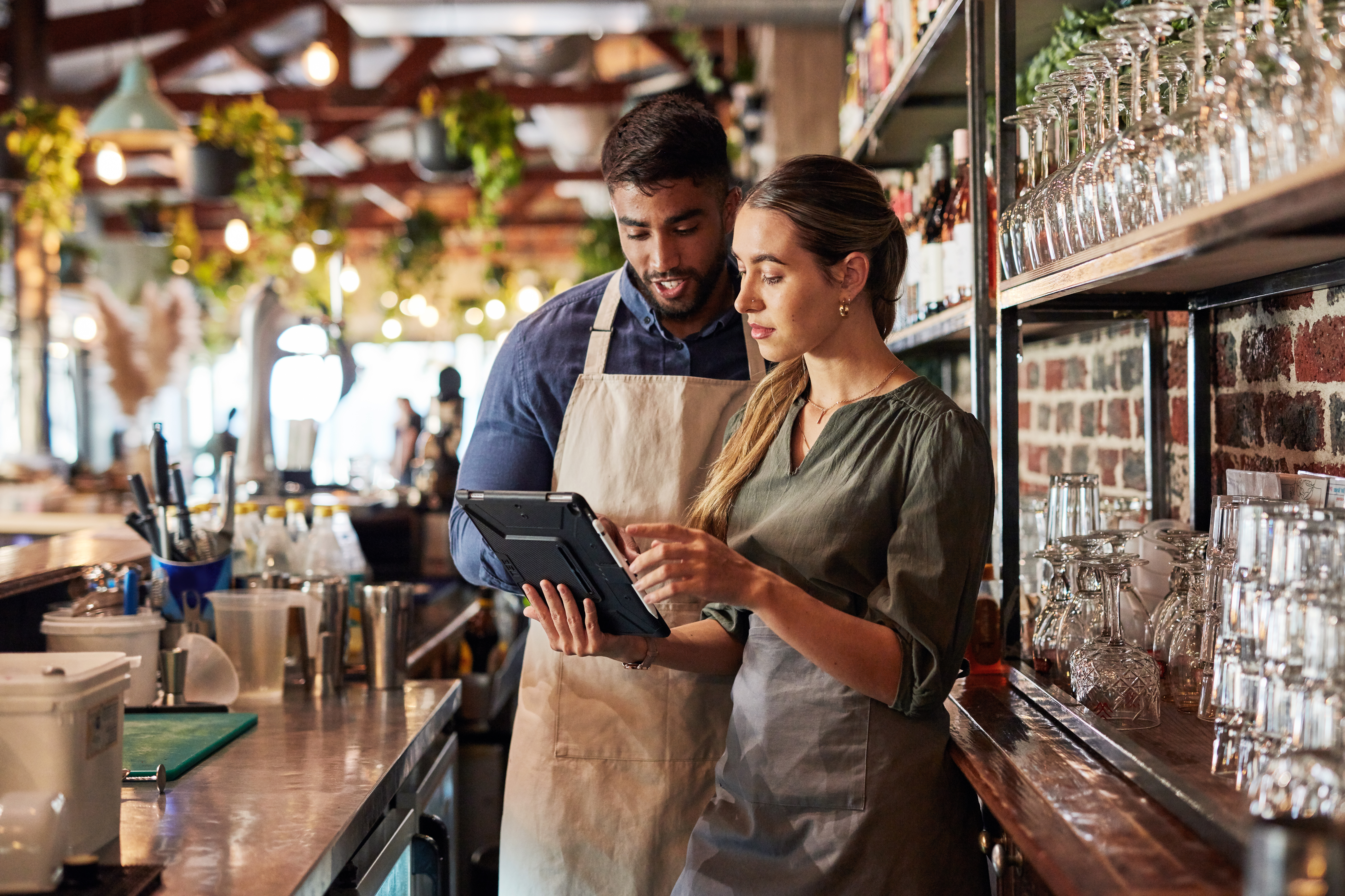 Two restaurant workers on a tablet