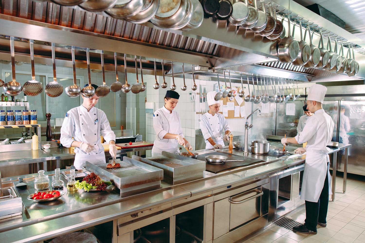 Chefs cooking food in restaurant kitchen